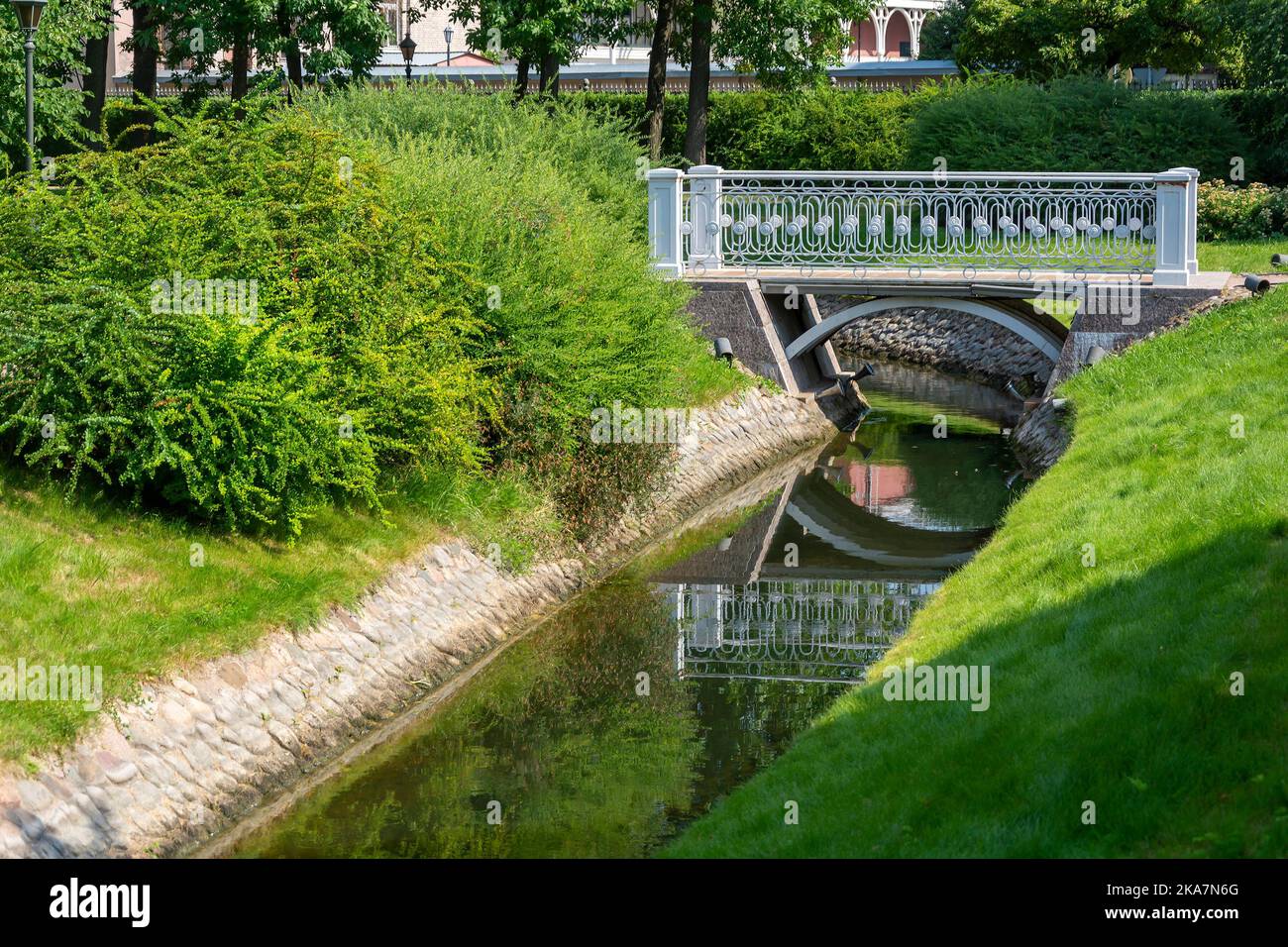 Decorative pedestrian bridge over a small canal in the park Stock Photo ...
