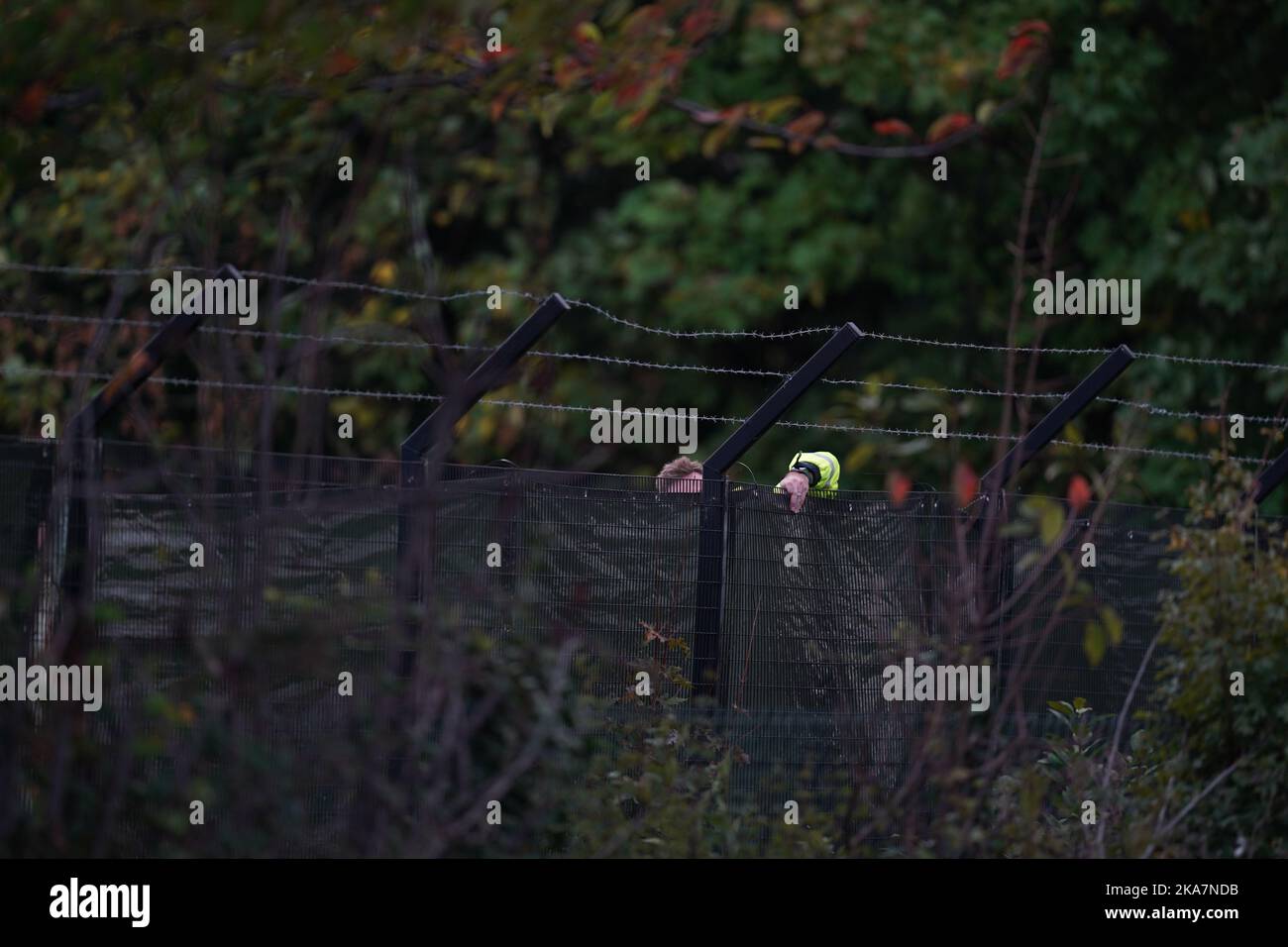 A member of security staff secures screens around the Manston ...