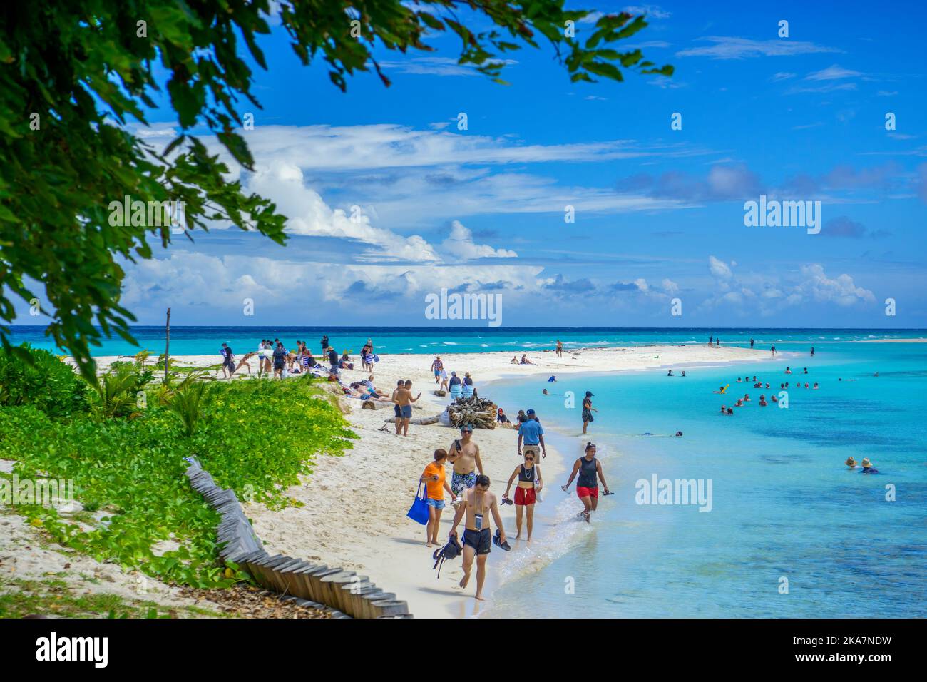 Tourists on white sandy beach on summers day, Conflict Islands, Papua ...