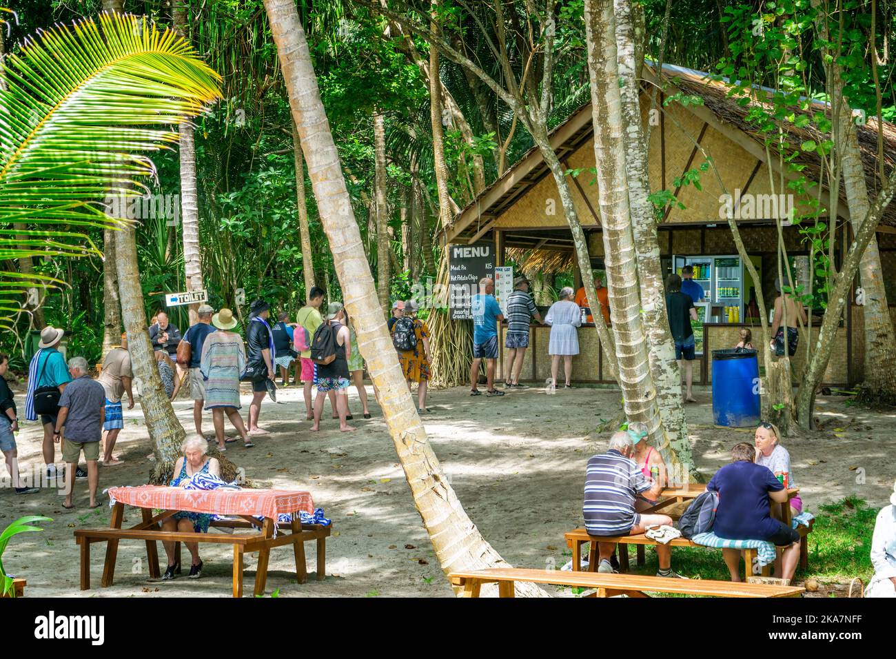 Holidaymakers queueing at beach bar, Conflict Islands, Papua New Guinea ...