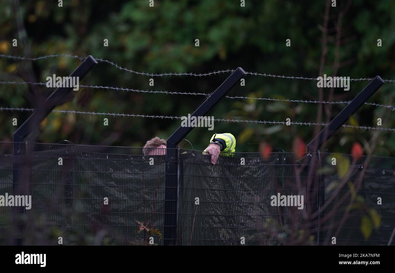 A member of security staff secures screens around the Manston ...