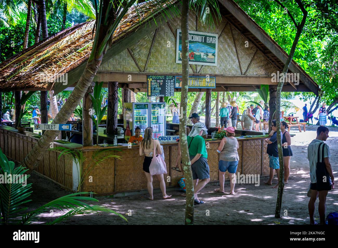 Holidaymakers queueing at beach bar, Conflict Islands, Papua New Guinea ...