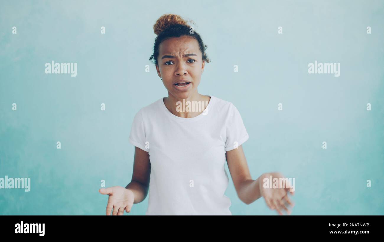 Portrait of angry African American woman talking and gesturing ...