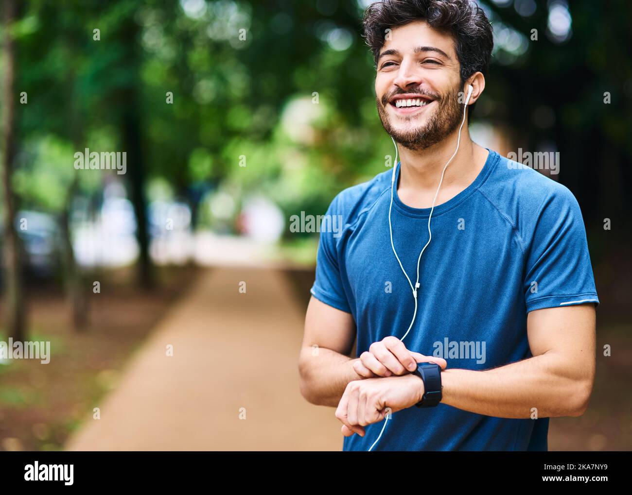 Time to clock another personal best. a sporty young man checking his ...