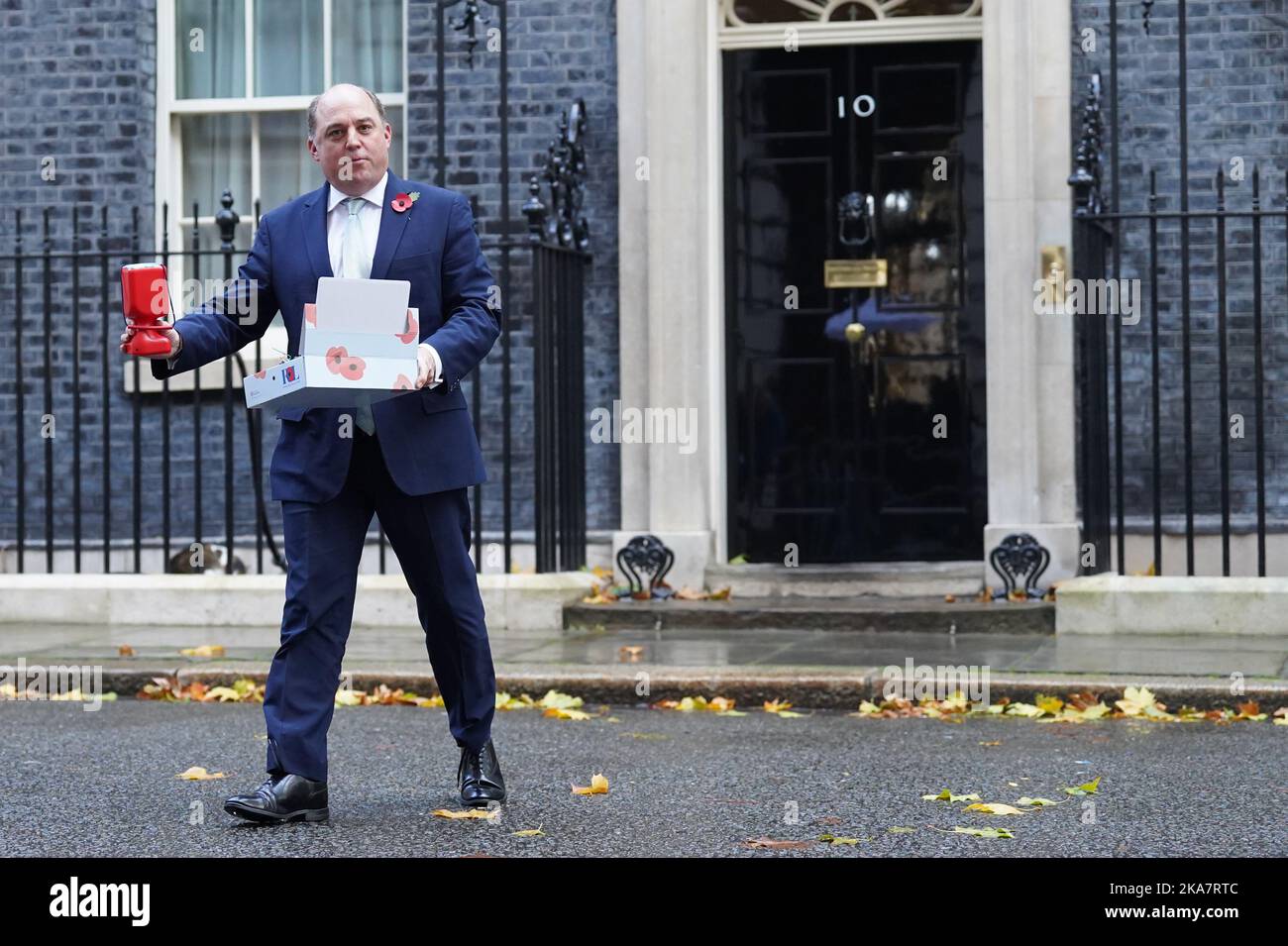 Defence Secretary Ben Wallace with a poppy collection box and poppies ...
