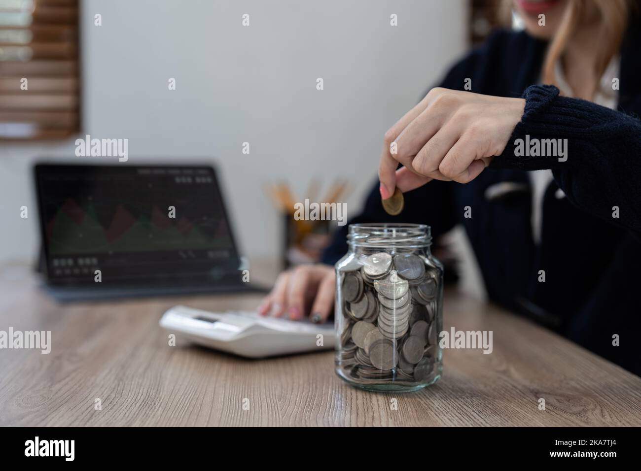 Businesswoman hands carrying a coin put to the saving pocket for her ...