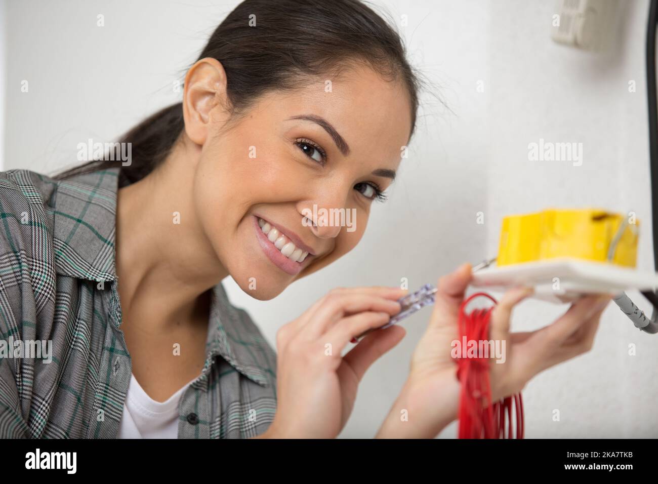 Female electrician fixing wire hi-res stock photography and images - Alamy
