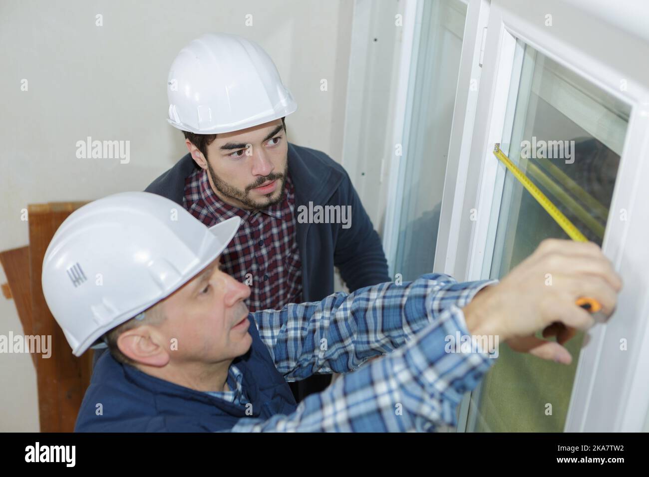 Construction workers installing new windows window hi-res stock ...