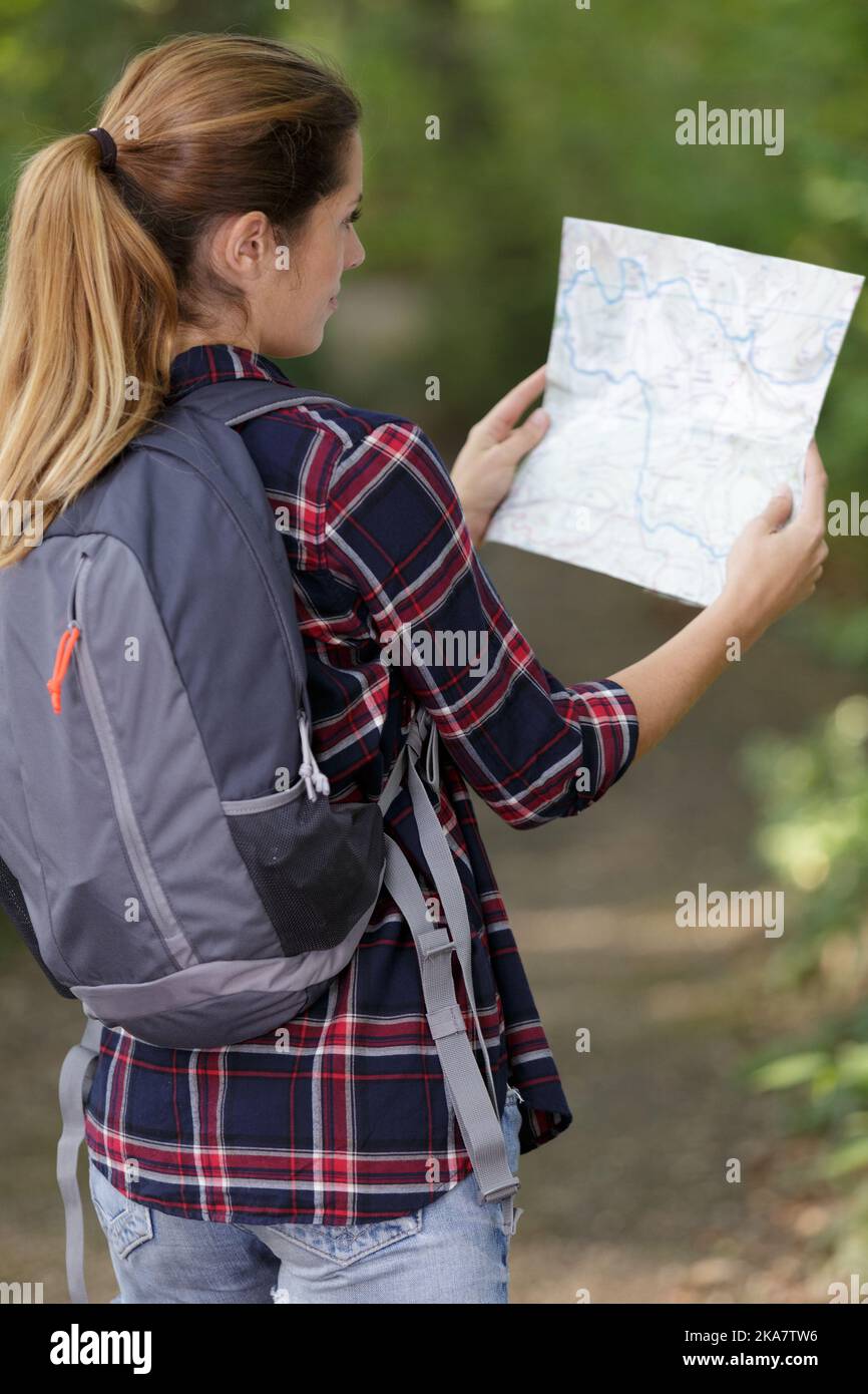 young woman backpacker hiker reading map Stock Photo - Alamy
