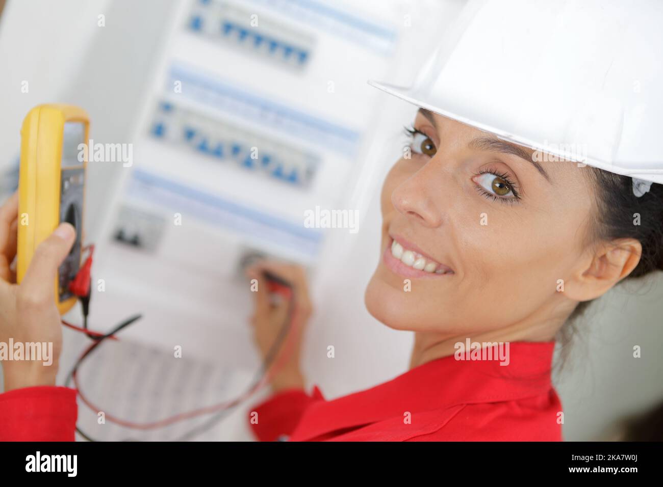 female electrician using multimeter looking over her shoulder Stock ...