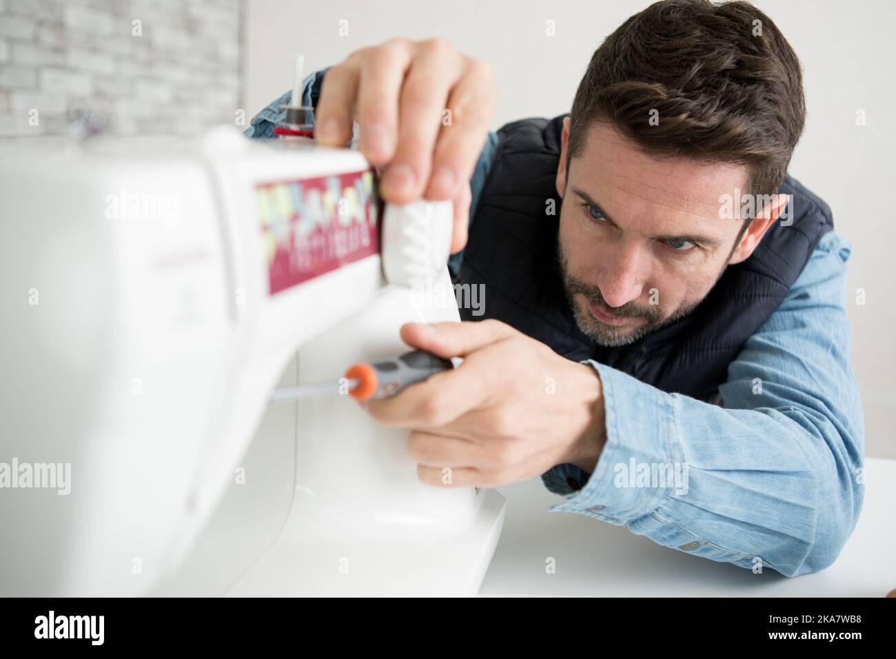 Repairman repairing sewing machine hi-res stock photography and images ...
