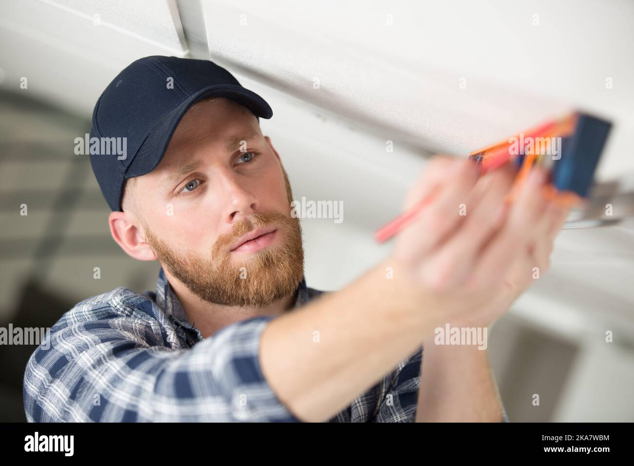 man checks the level of the window sill Stock Photo - Alamy