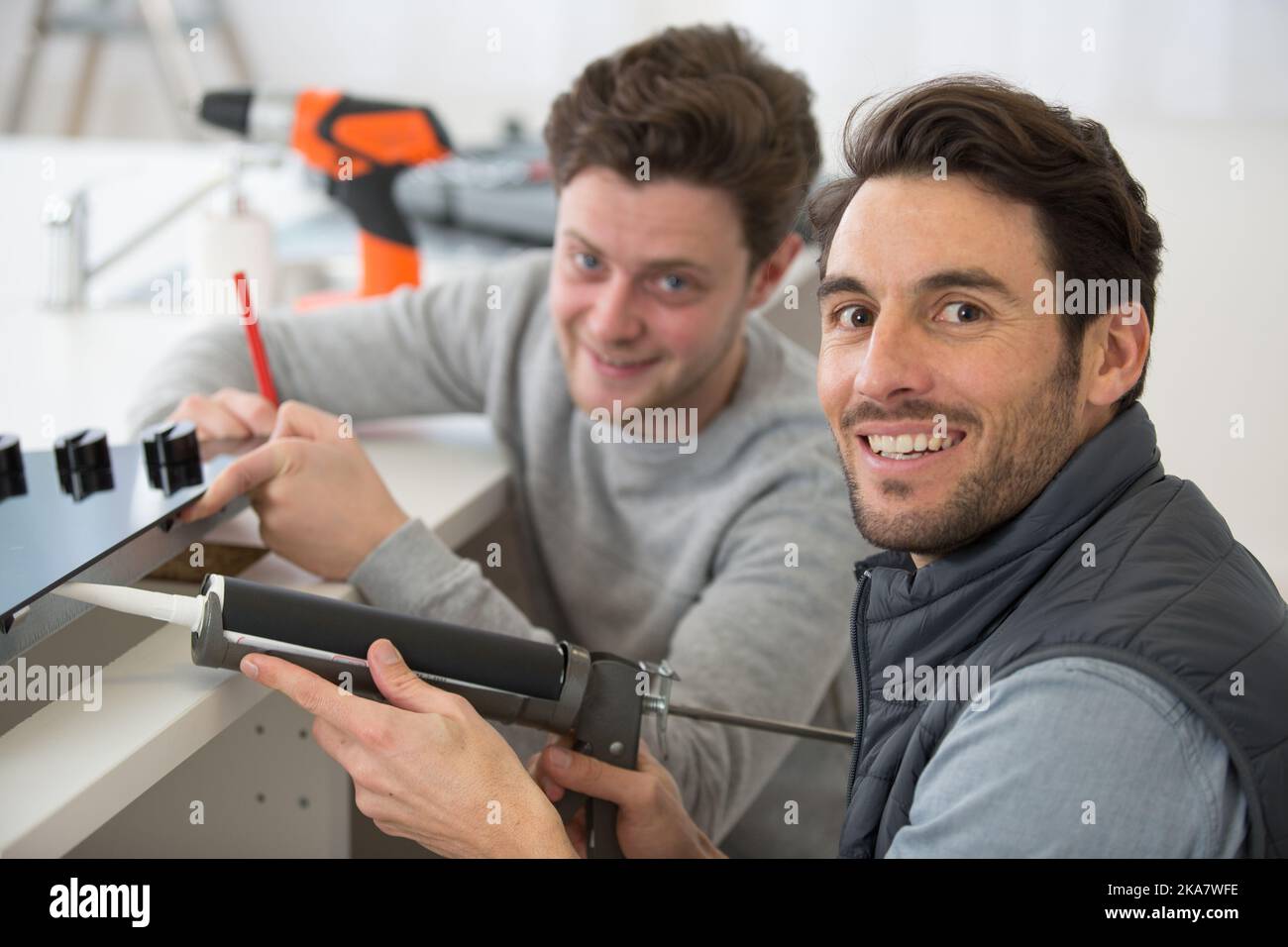 young apprentice with teacher working Stock Photo - Alamy