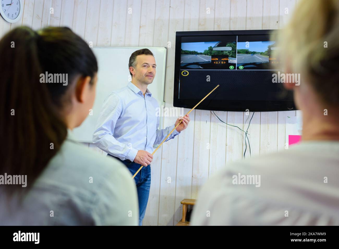 driving instructor pointing at board in a classroom Stock Photo - Alamy