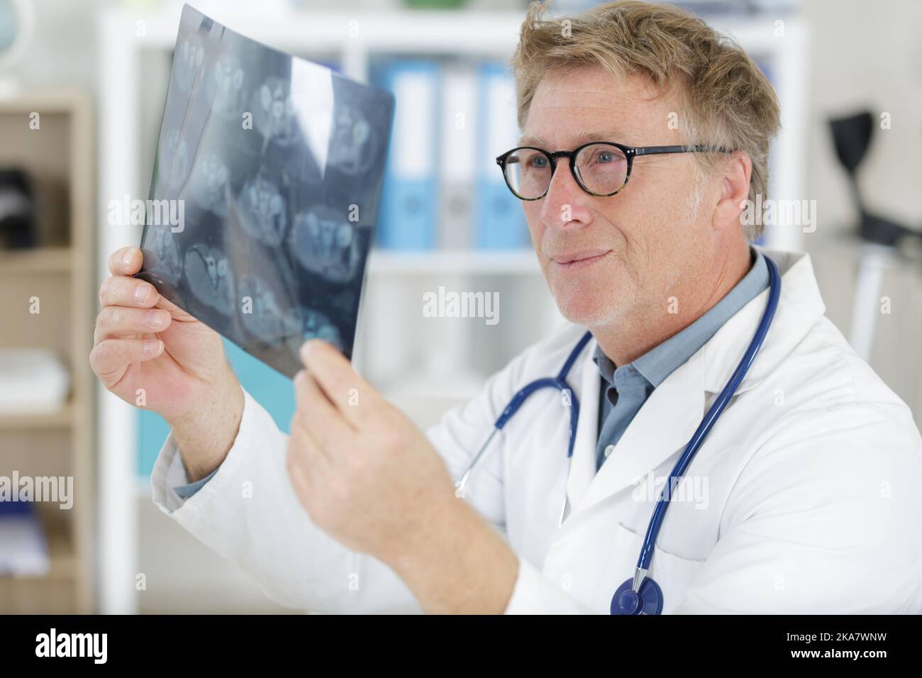 senior man medical doctor looking at x-rays in a hospital Stock Photo ...