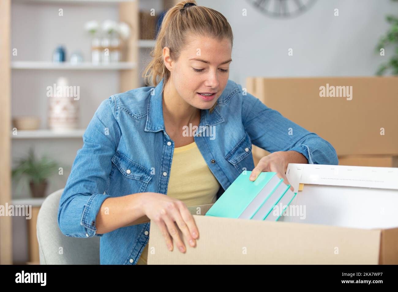 attractive young woman is moving in new house Stock Photo - Alamy