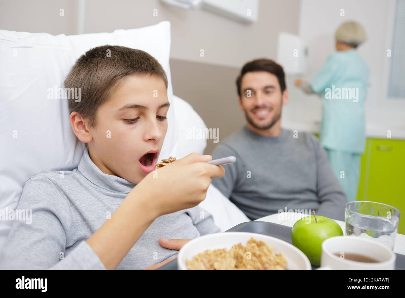 boy eating meal in hospital bed Stock Photo - Alamy