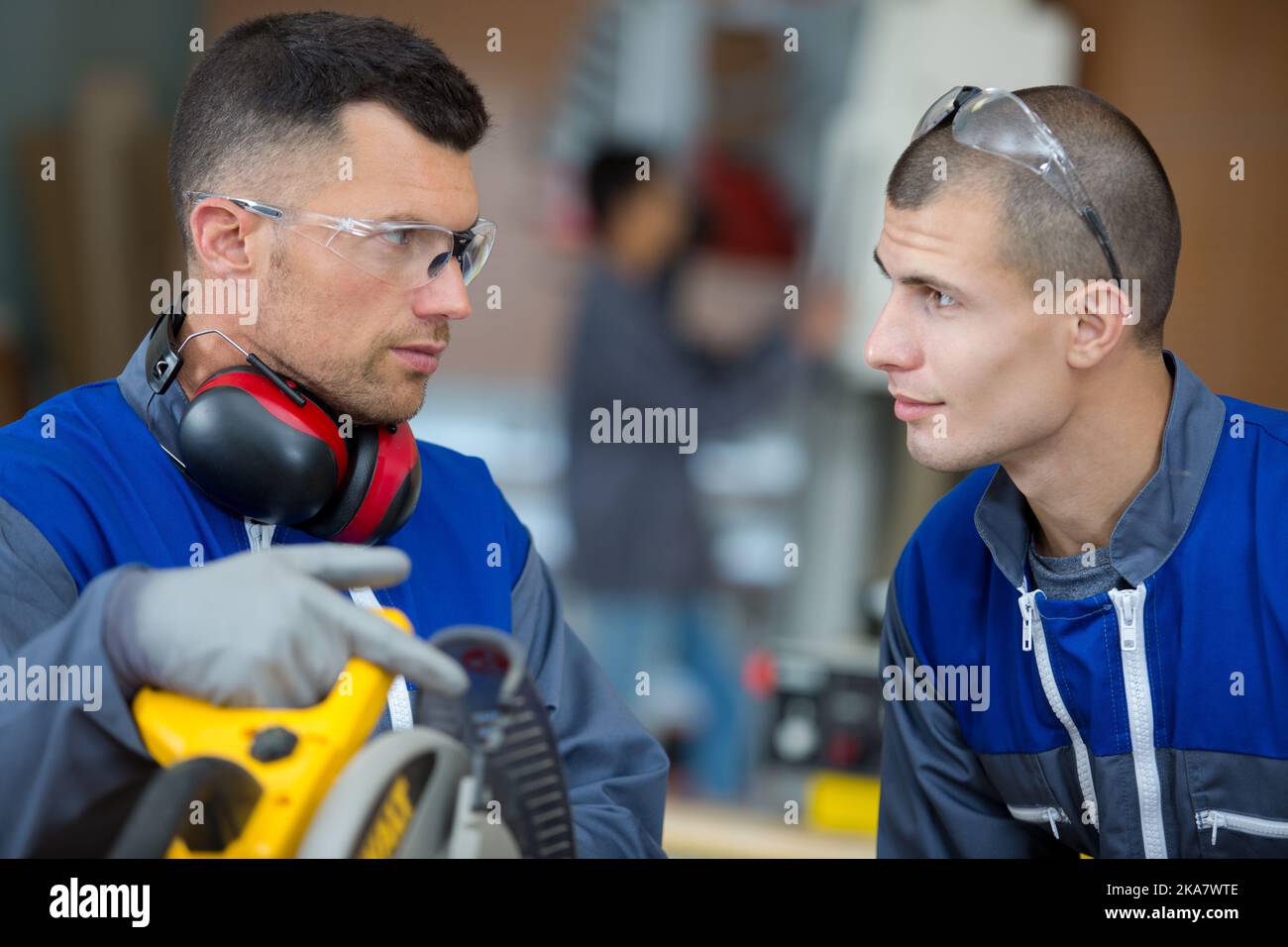 two male machinists are talking Stock Photo - Alamy