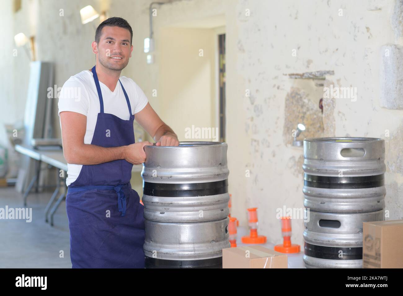 a brewery worker carrying barrels Stock Photo - Alamy