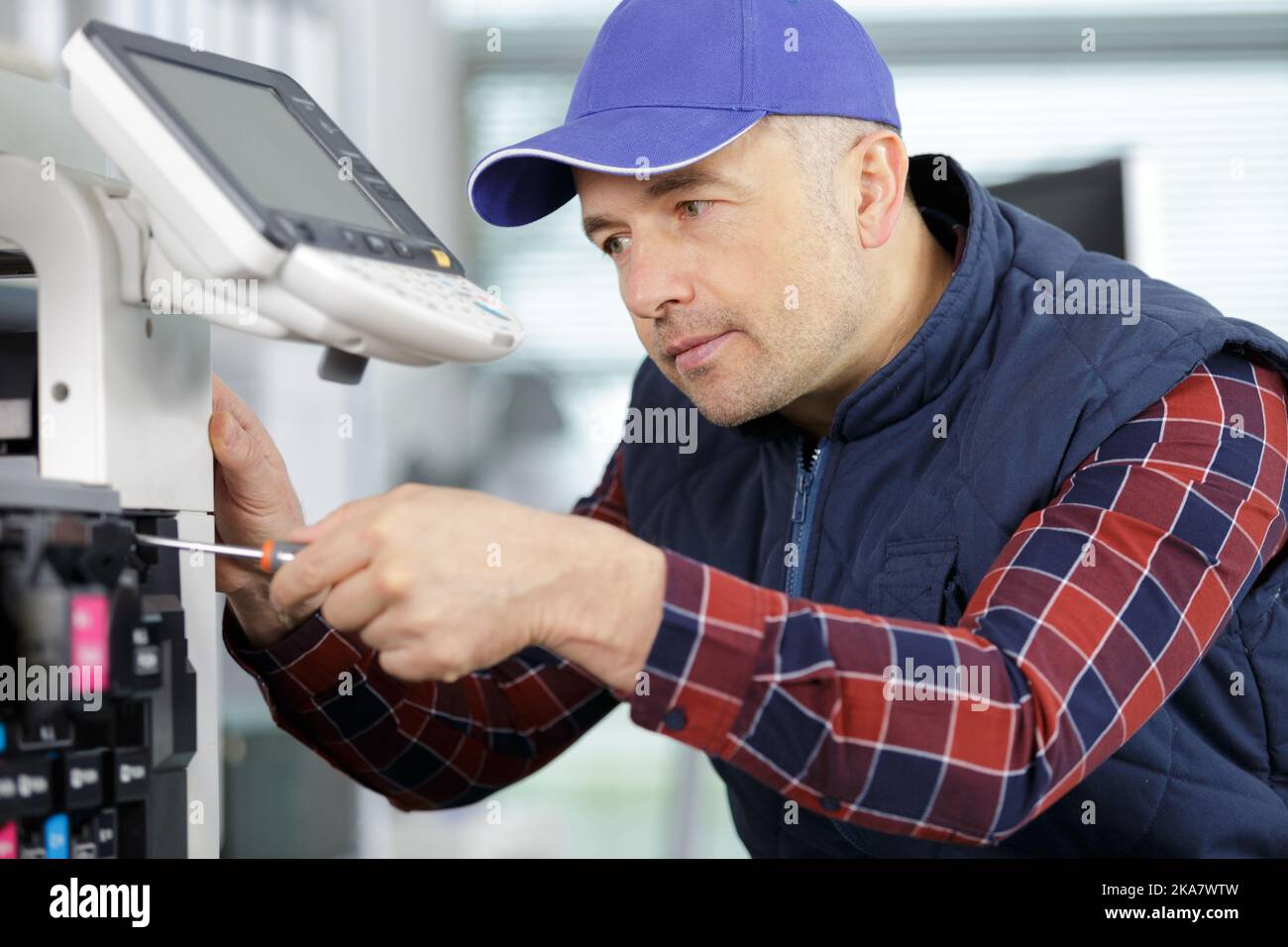 middle age man fixing a printer Stock Photo - Alamy