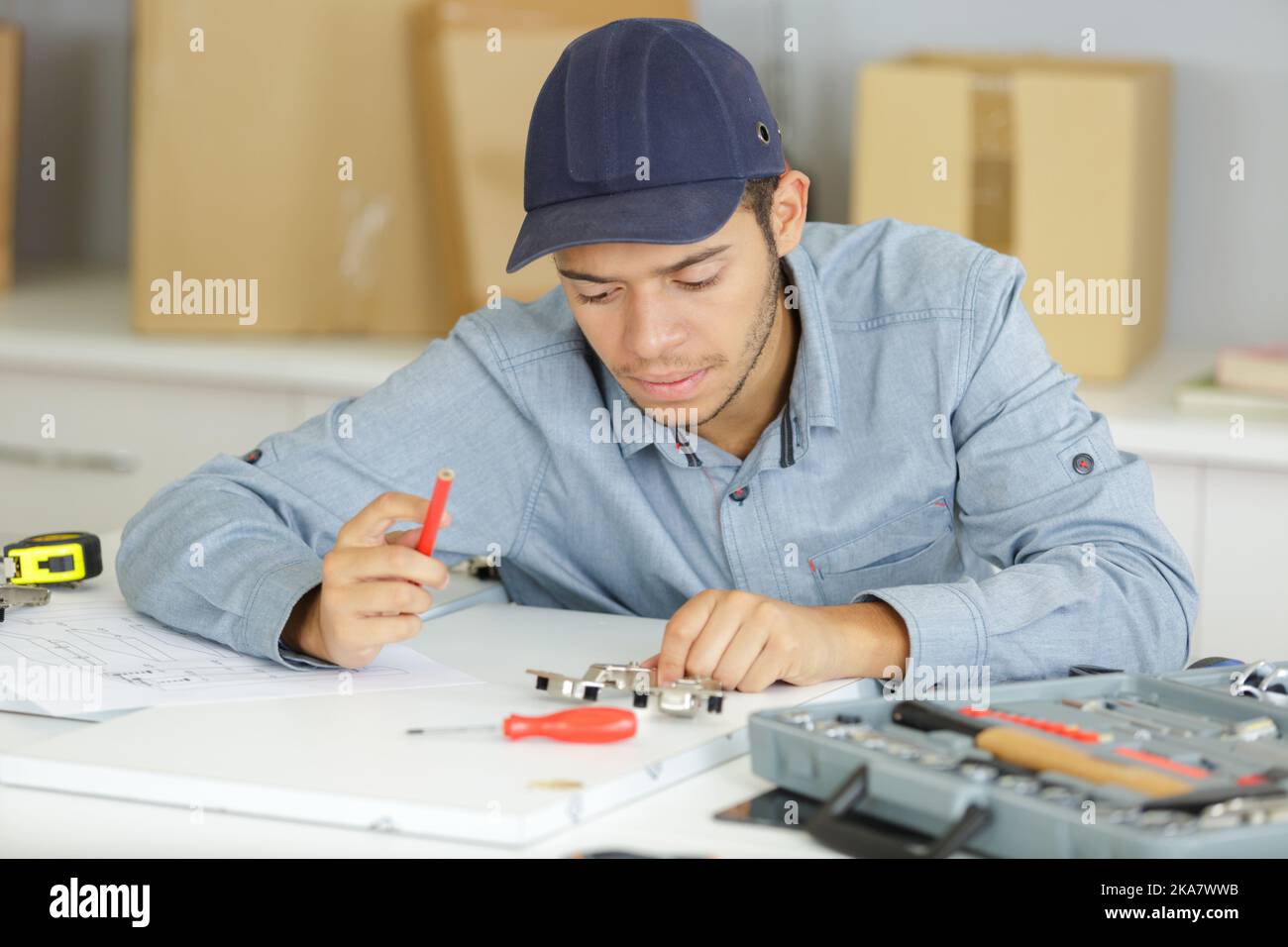 a male worker repairing something Stock Photo - Alamy