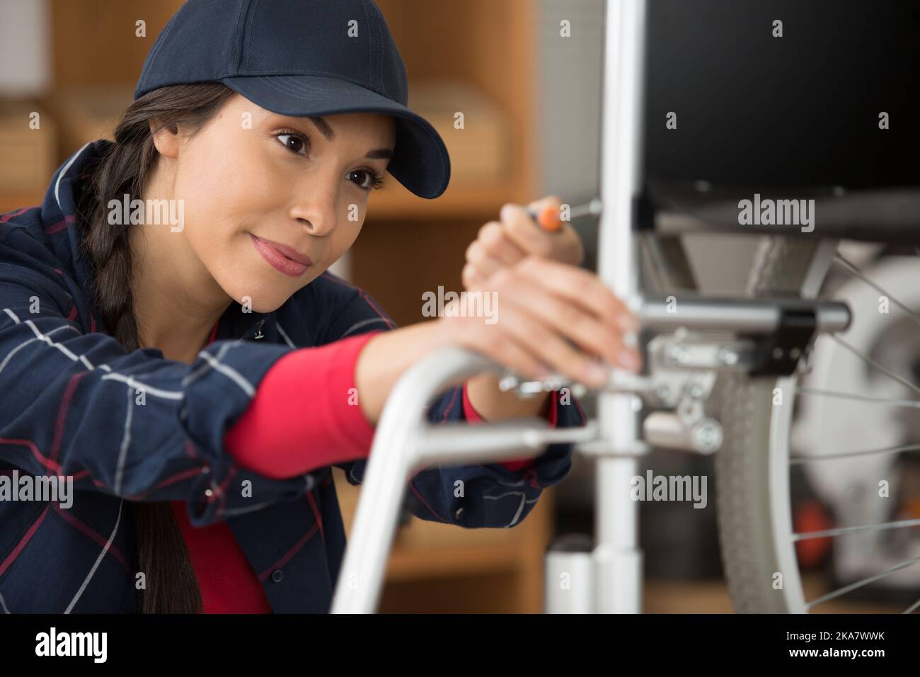 young female fixing a wheelchair Stock Photo - Alamy