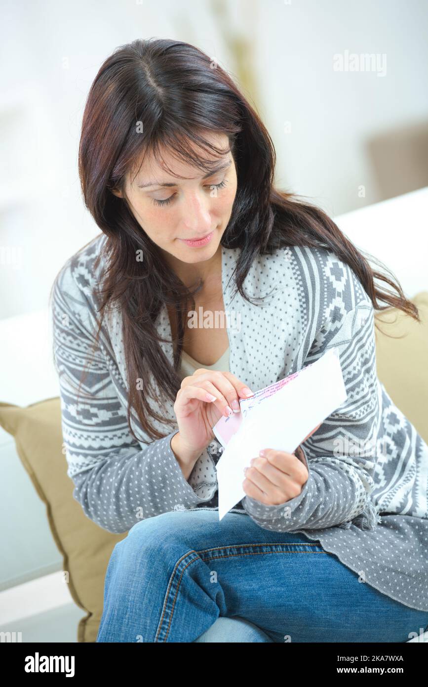 a woman is opening a the letter Stock Photo - Alamy