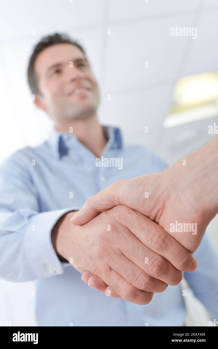 two men during important office handshake Stock Photo - Alamy