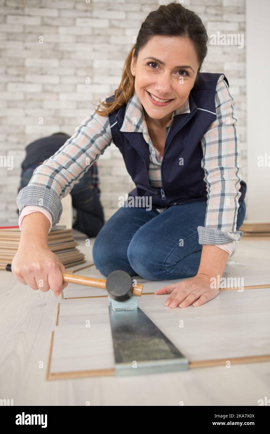 happy woman fitting new flooring Stock Photo - Alamy