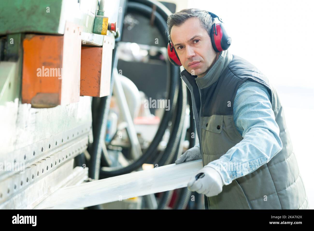factory man worker holding metal sheet in workshop Stock Photo - Alamy
