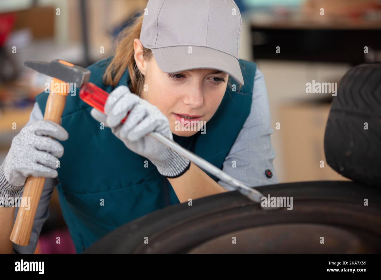 female mechanic in uniform with car tire Stock Photo - Alamy