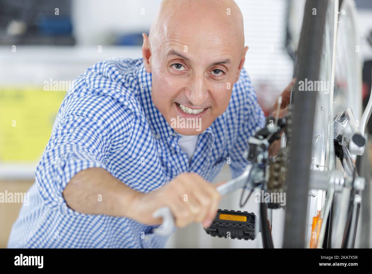 Man fixing bicycle home male hi-res stock photography and images - Alamy