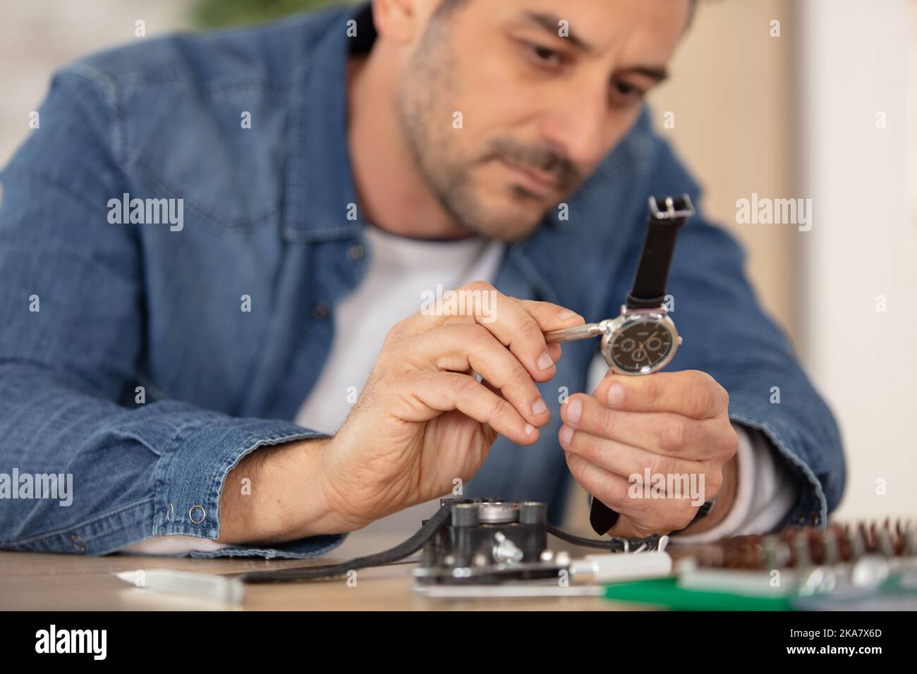 patient man repairing a watch Stock Photo - Alamy
