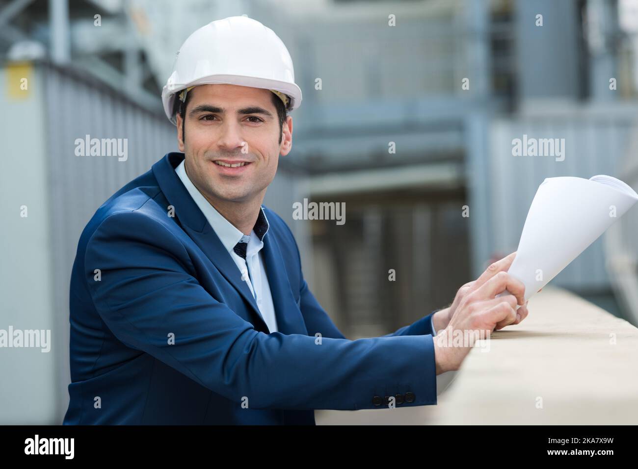 engineer with blueprint at building area Stock Photo - Alamy