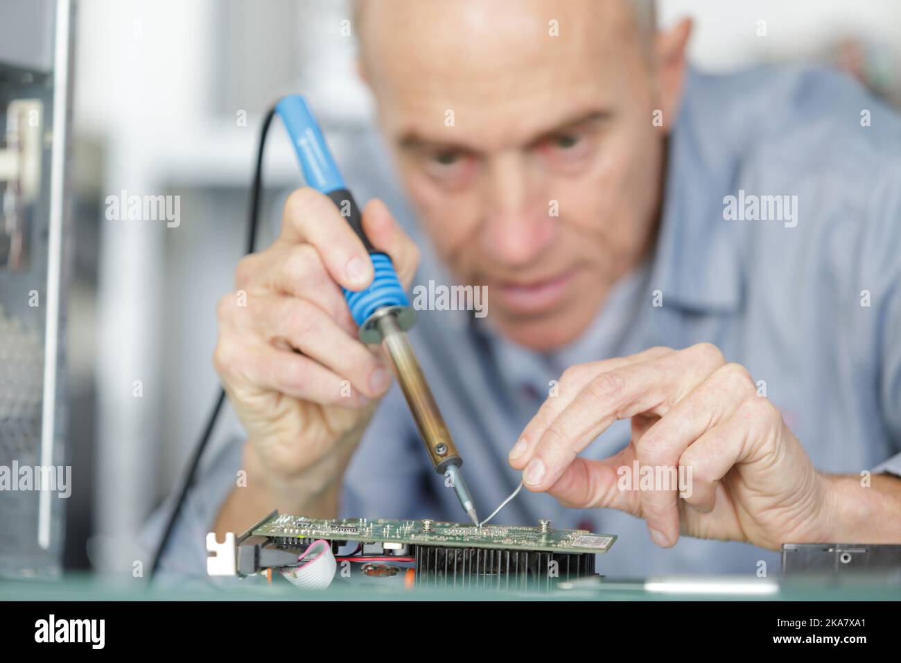 technician repairing a tablet by soldering iron in the lab Stock Photo ...