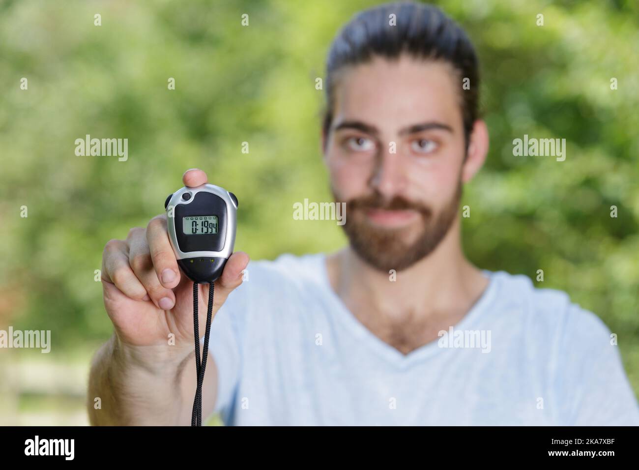 portrait of serious man showing stopwatch Stock Photo - Alamy