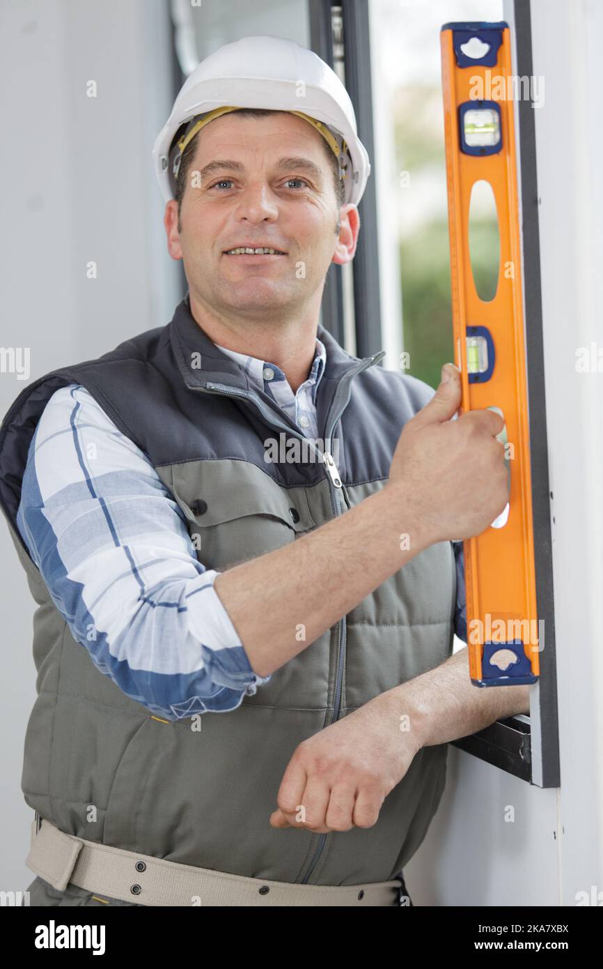 happy inspector checking alignment of window frame Stock Photo - Alamy