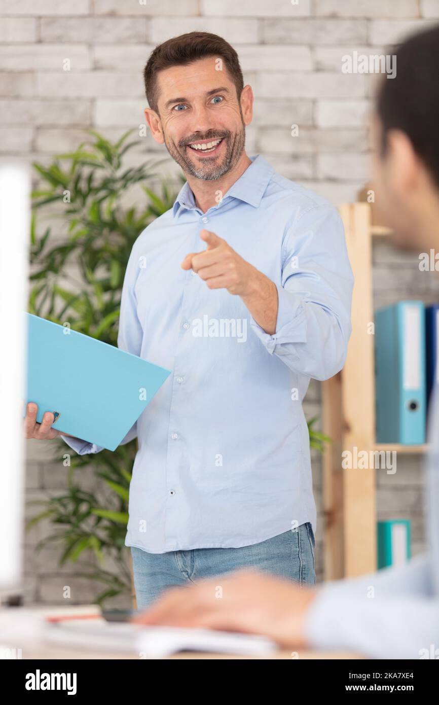 student man points finger at you while smiling Stock Photo - Alamy