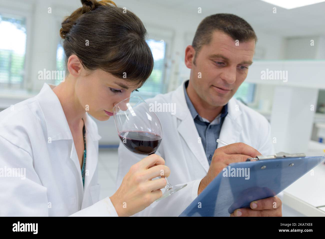 experts in white coats checking wine quality in lab Stock Photo - Alamy