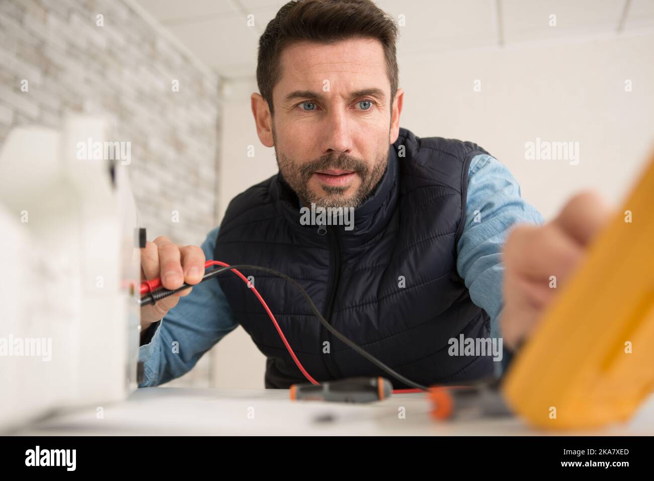 male electrician testing socket voltage Stock Photo - Alamy