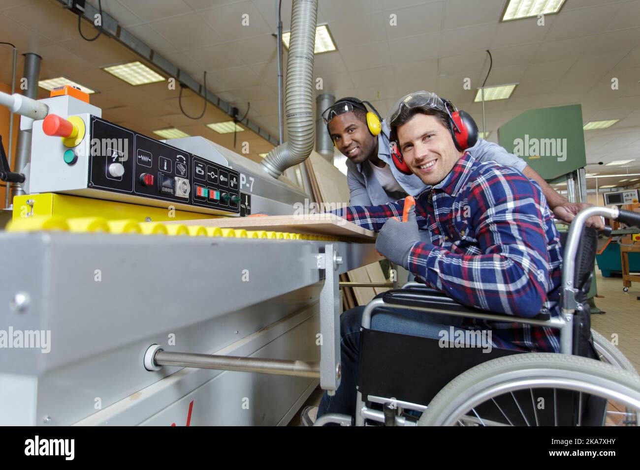 disabled factory worker in wheelchair with his colleague Stock Photo ...