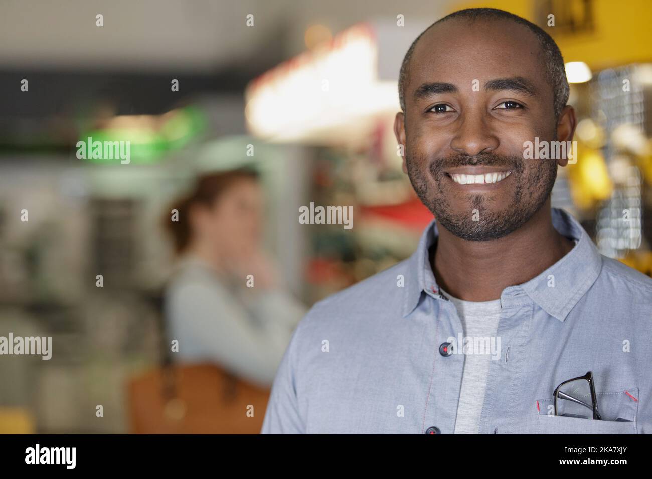 handsome hardware store salesman standing next to fasteners shelf Stock ...