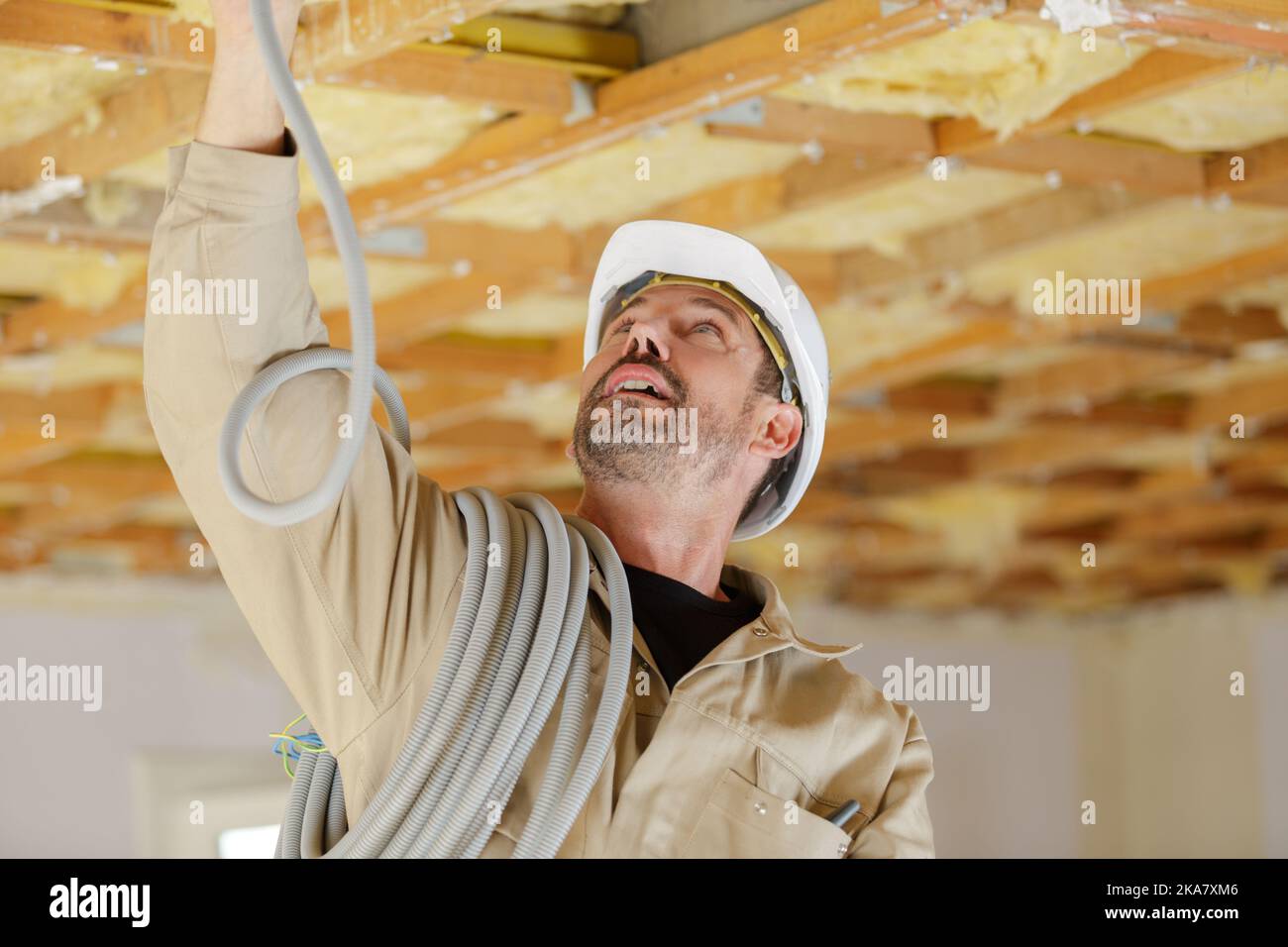 portrait of a builder installing pipes Stock Photo - Alamy