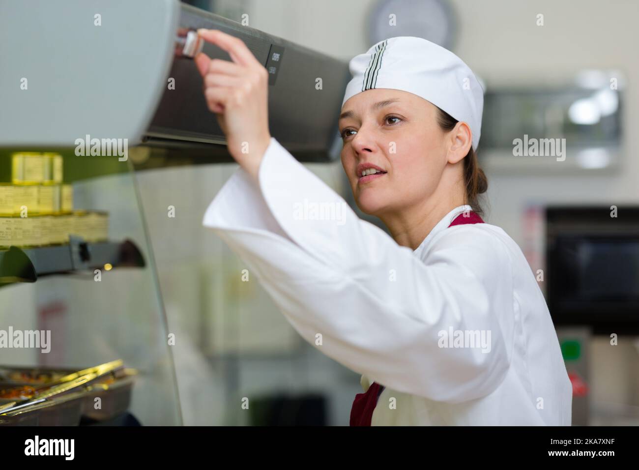 buffet female worker checking machine Stock Photo - Alamy