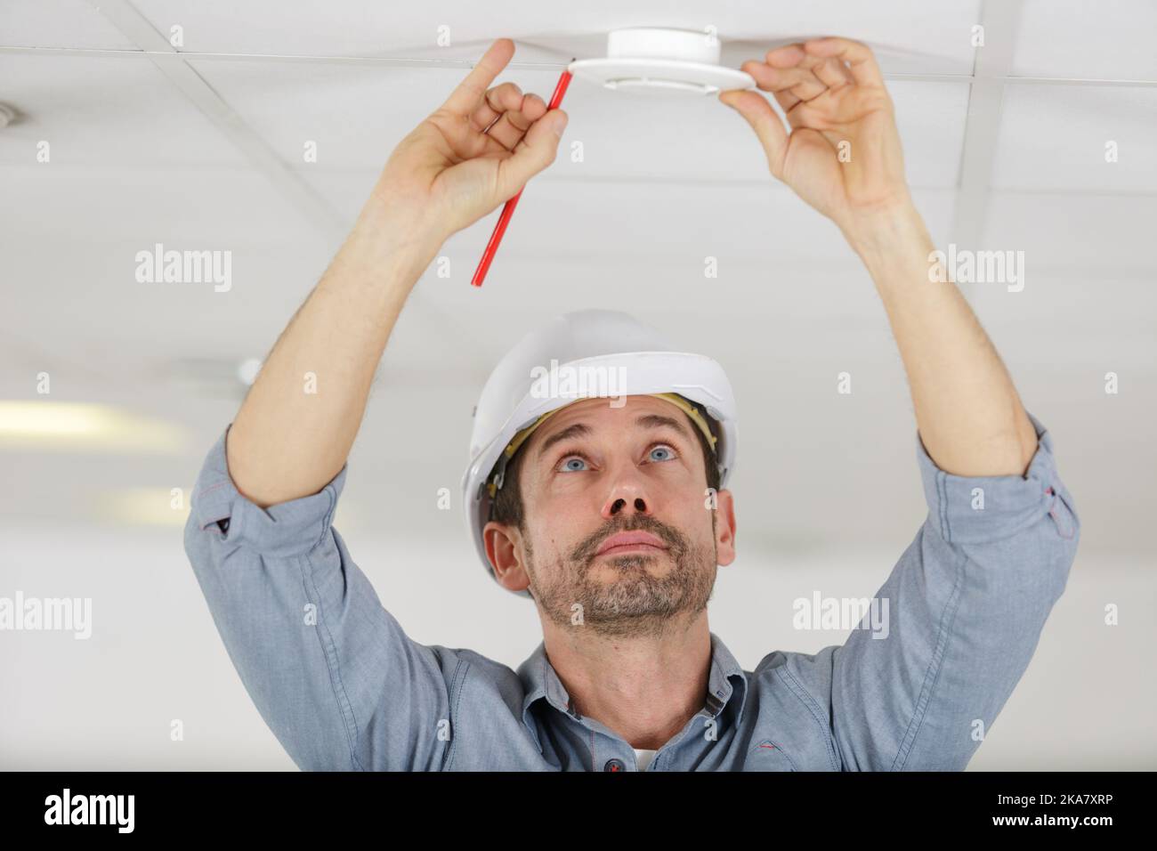 workman or builder marking a spot with pencil Stock Photo - Alamy