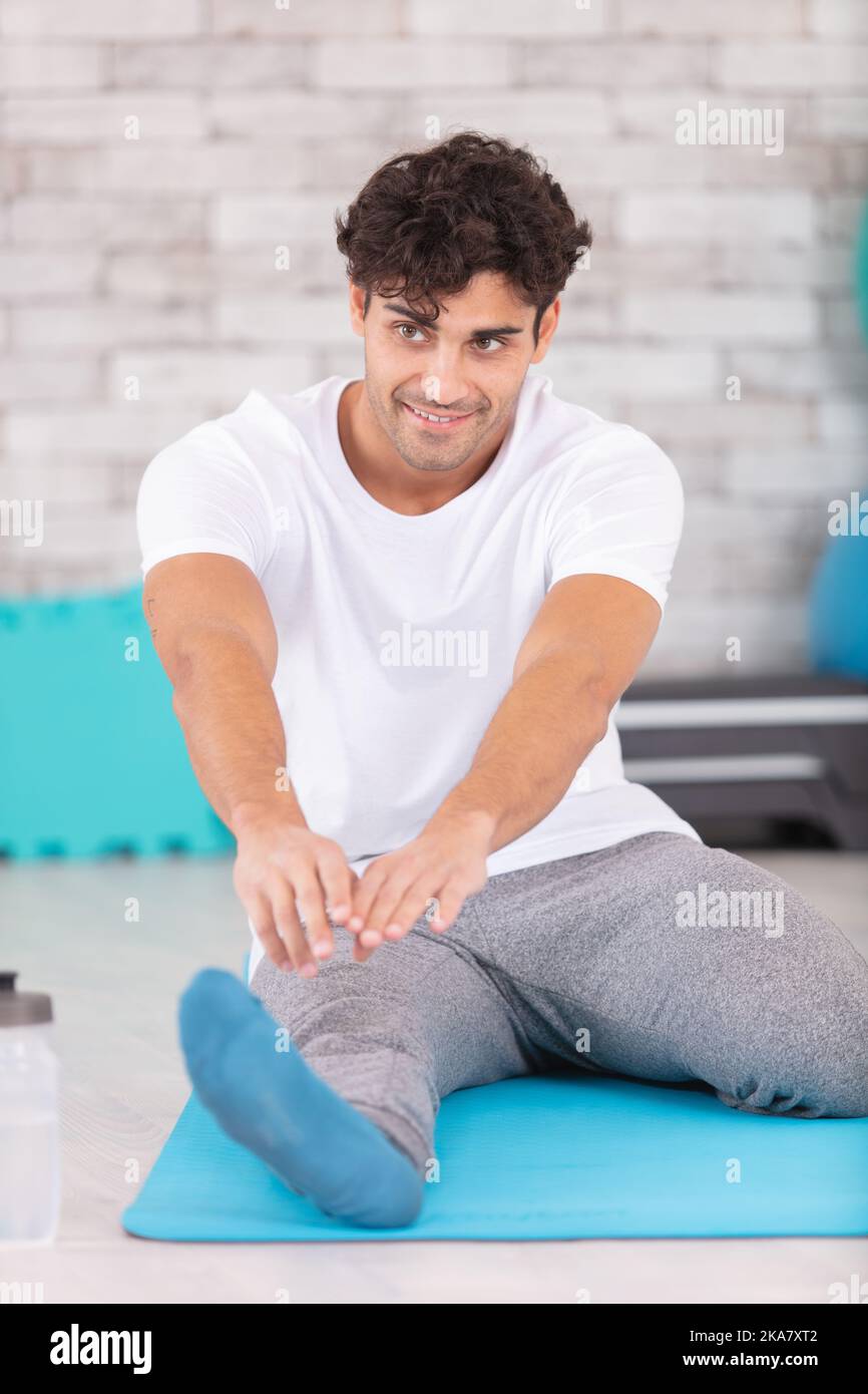 handsome young man doing hamstring stretch exercise Stock Photo - Alamy