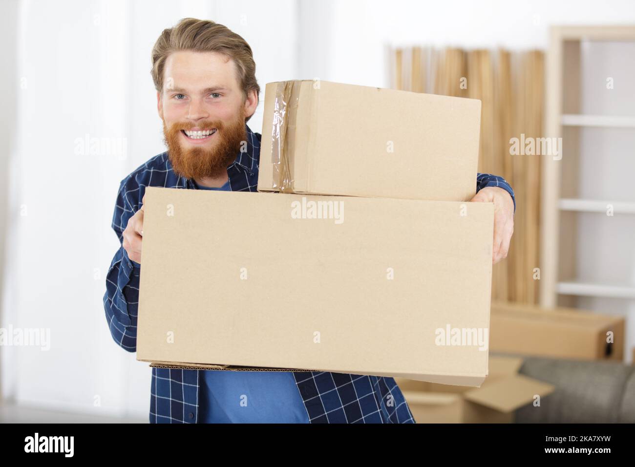 happy man carrying stack of heavy cardboard boxes Stock Photo - Alamy