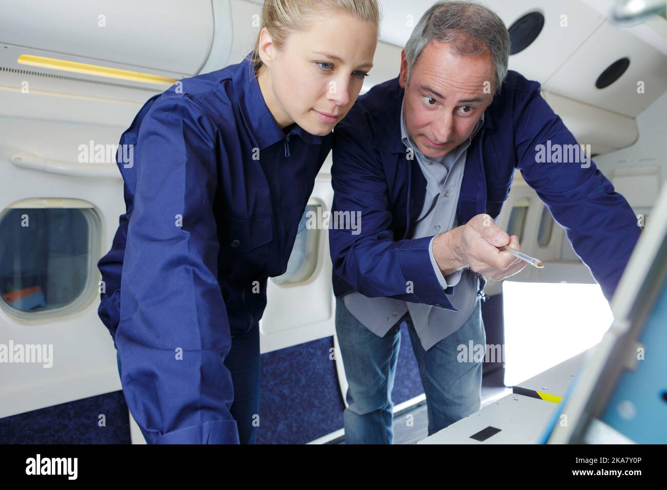 portrait of a flight mechanic checking something Stock Photo - Alamy