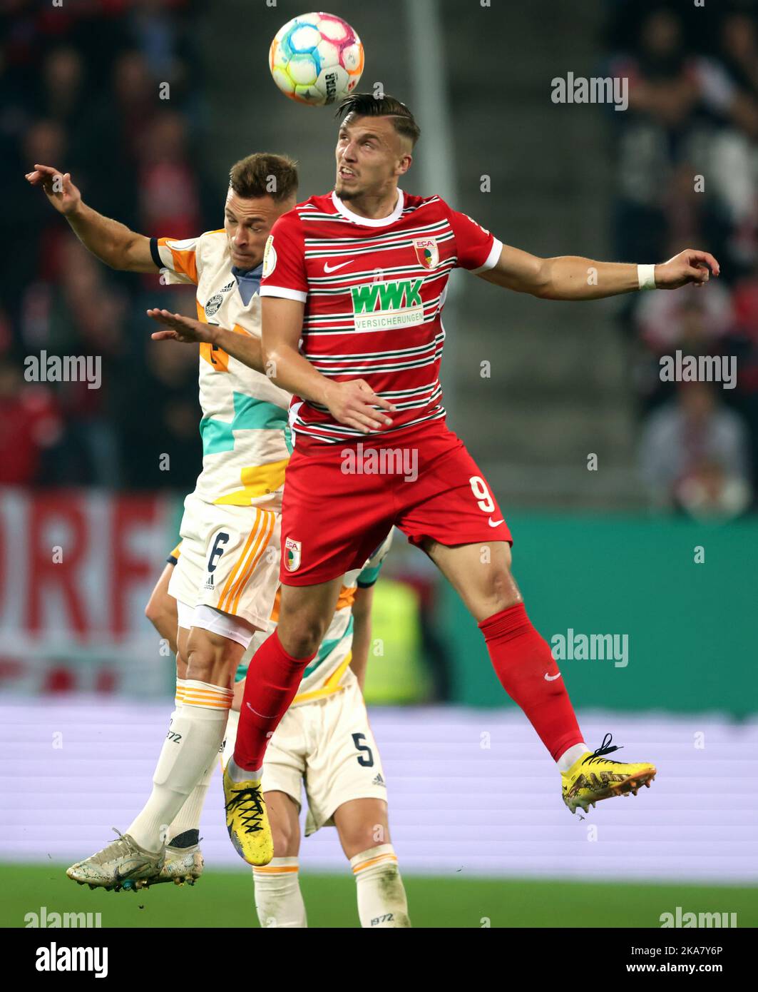 Joshua Kimmich of Bayern Muenchen Emedin Demirovic of FC Augsburg FC ...