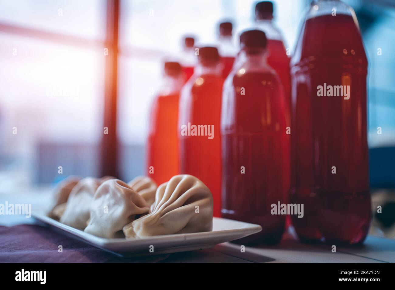 set of georgian khinkali with homemade red wine or chacha in plastic ...
